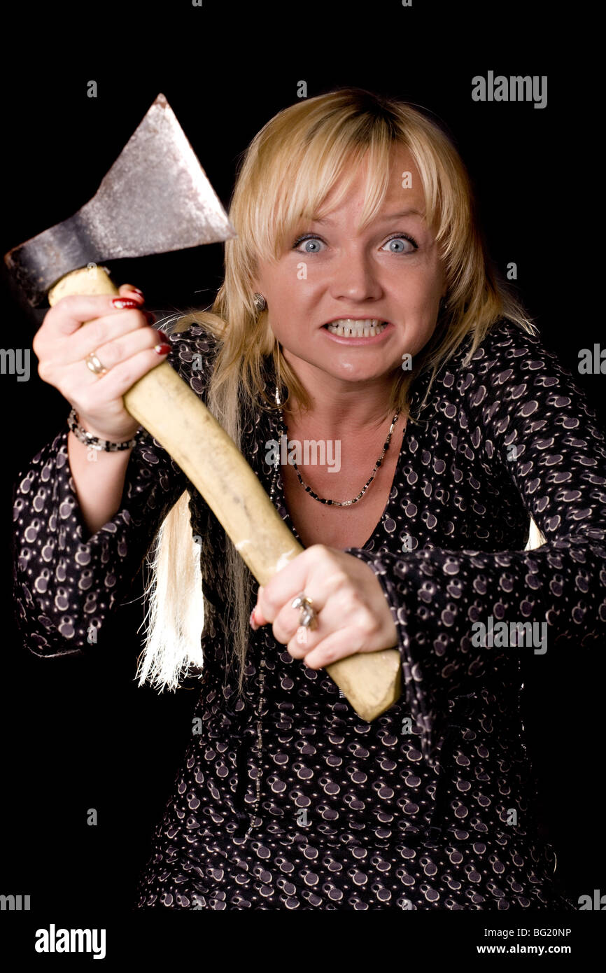 fury blonde woman with axe on black background Stock Photo - Alamy