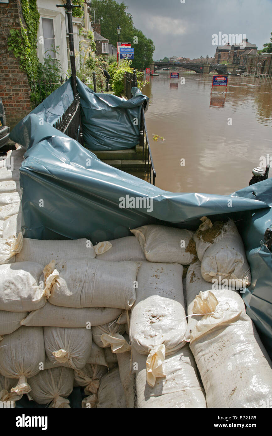 Sandbag flood prevention barrier alongside the River Ouse, York, United ...
