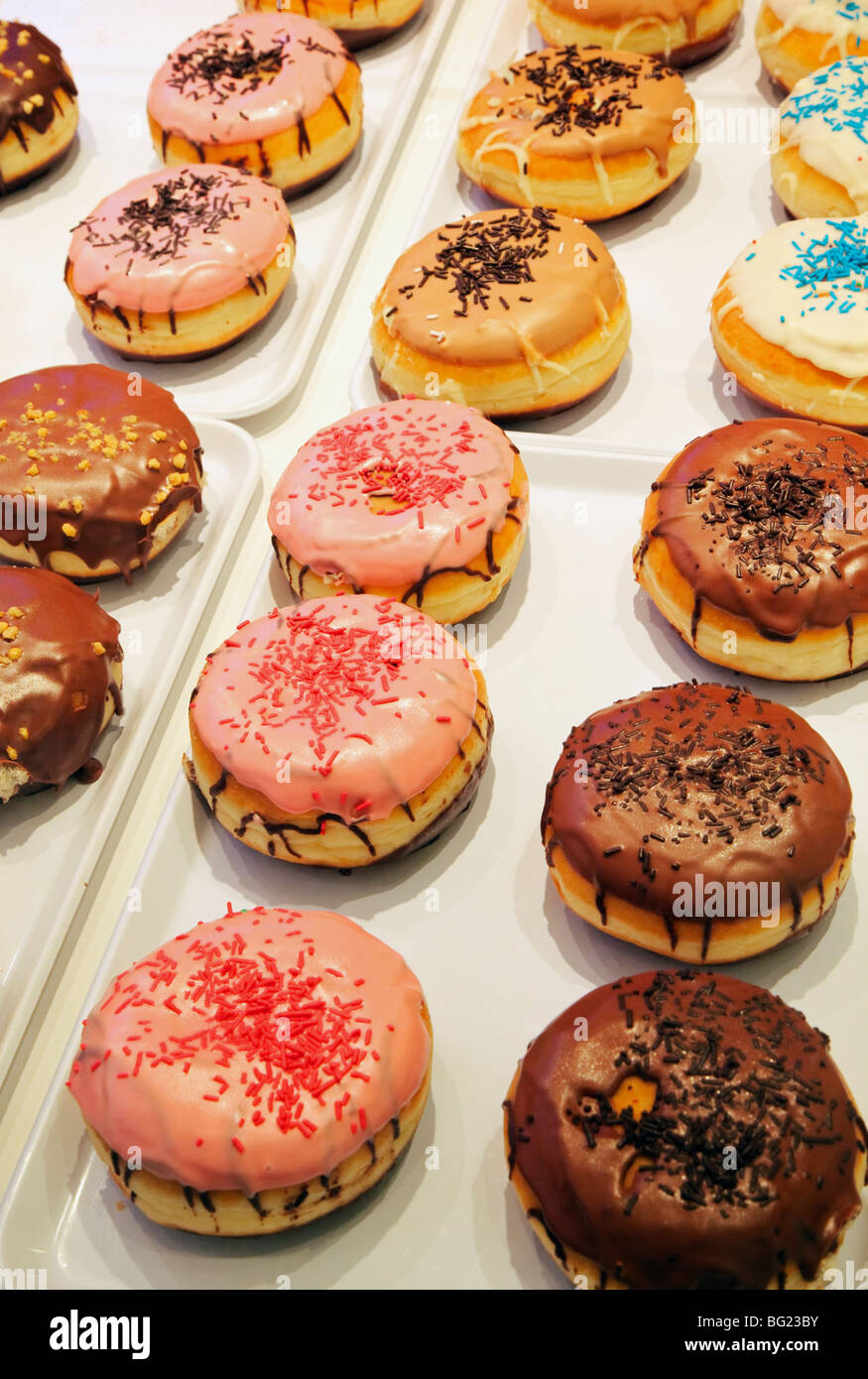 Iced doughnuts on display Stock Photo - Alamy