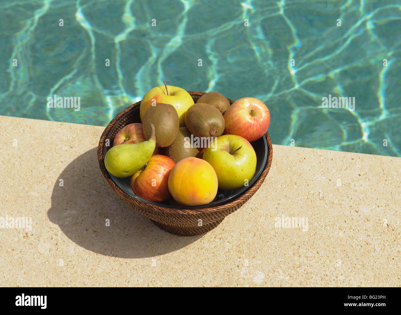 Bowl of fruit by a pool Stock Photo - Alamy