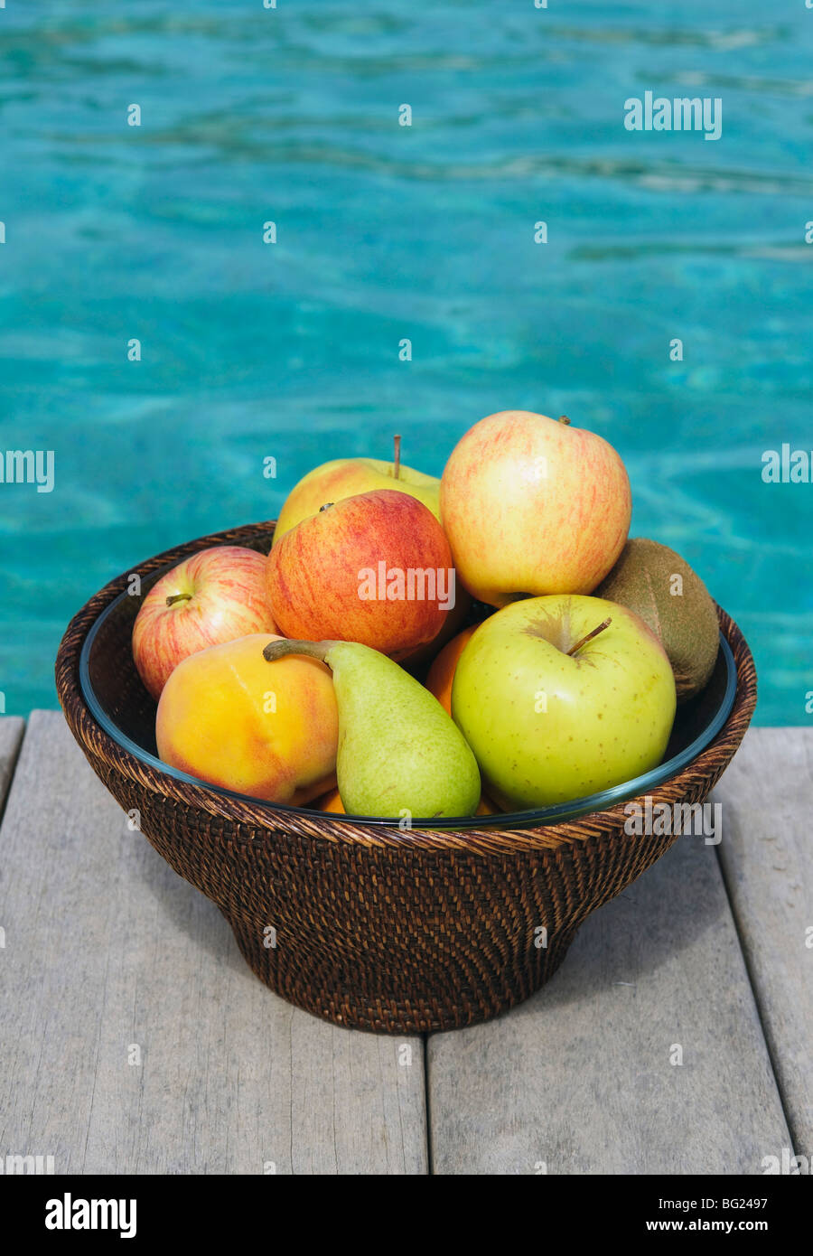 Bowl of fruit by a pool Stock Photo - Alamy