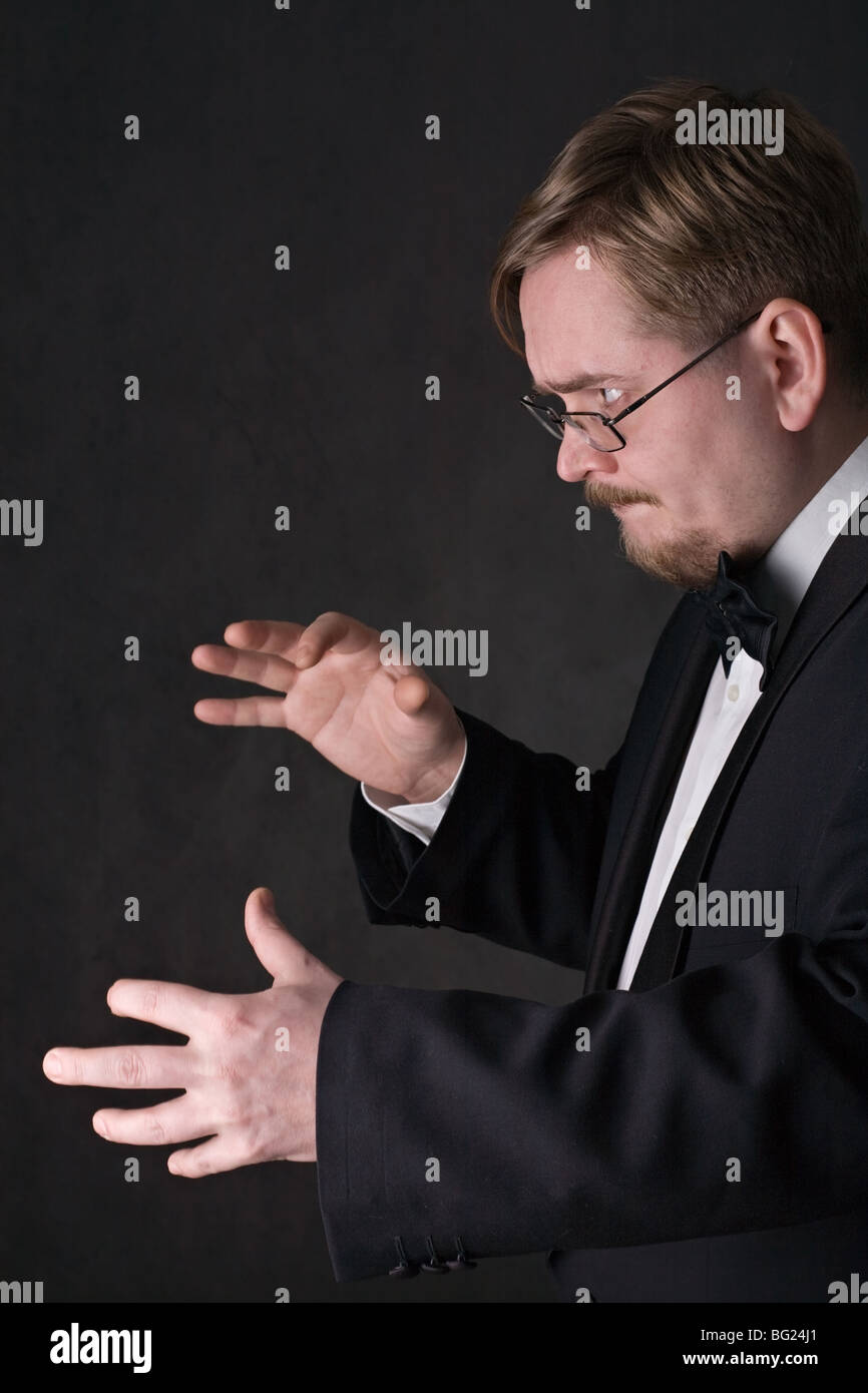Choir conductor wearing a black tuxedo, photo on black background Stock ...