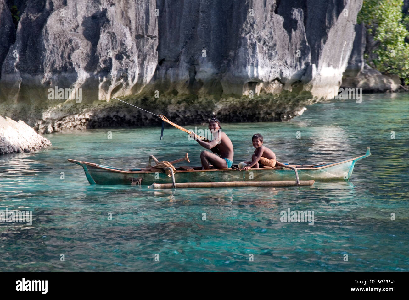 Native Tagbanua fishing with traditional paraphernalia in bay enclosed ...