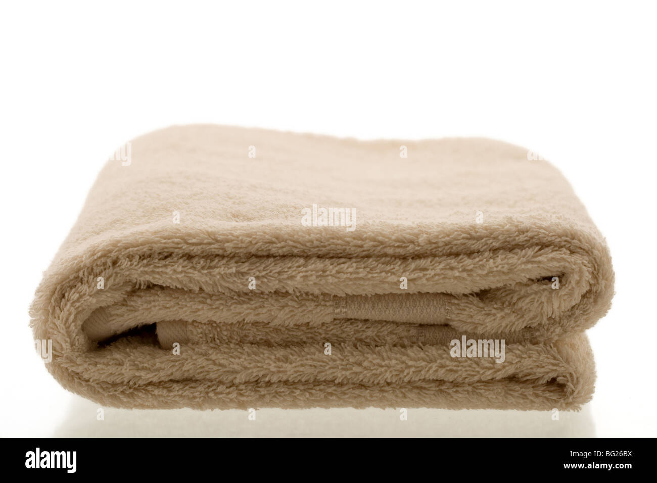 Light brown folded towel on white Stock Photo - Alamy