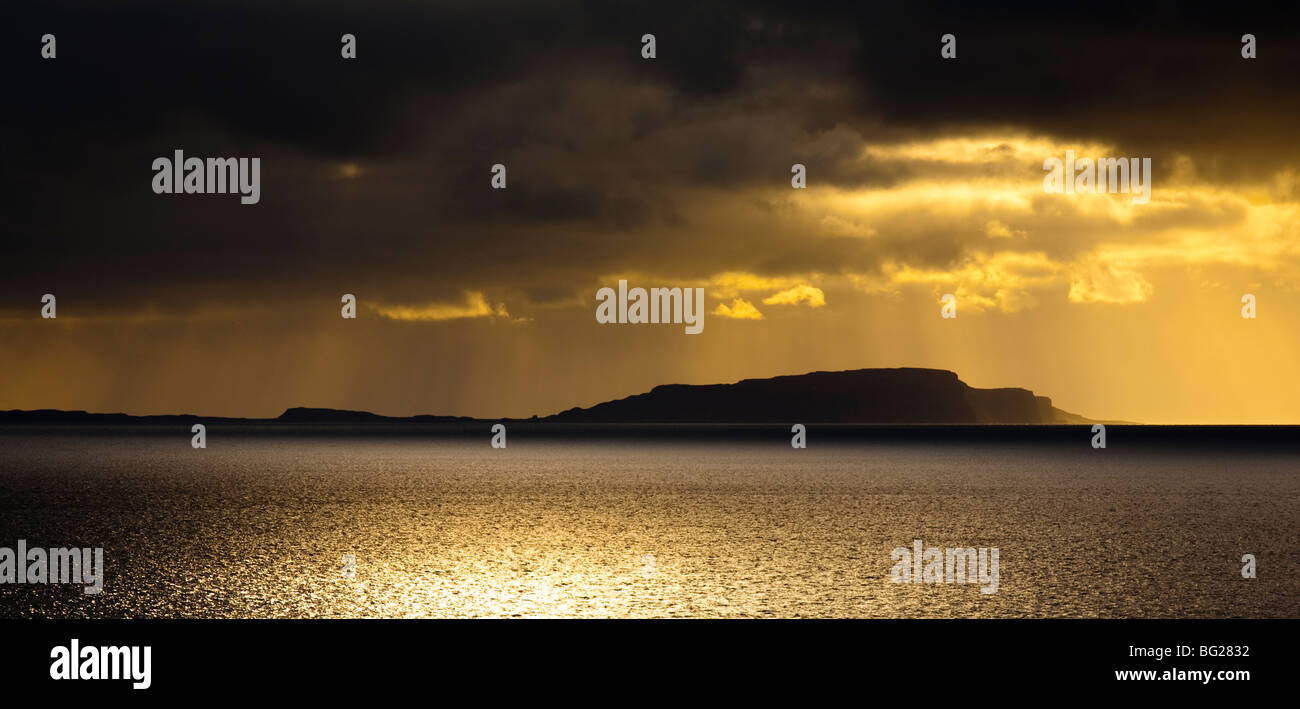 Scotland, Western Isles, Isle of Soay. Shafts of light from the setting ...