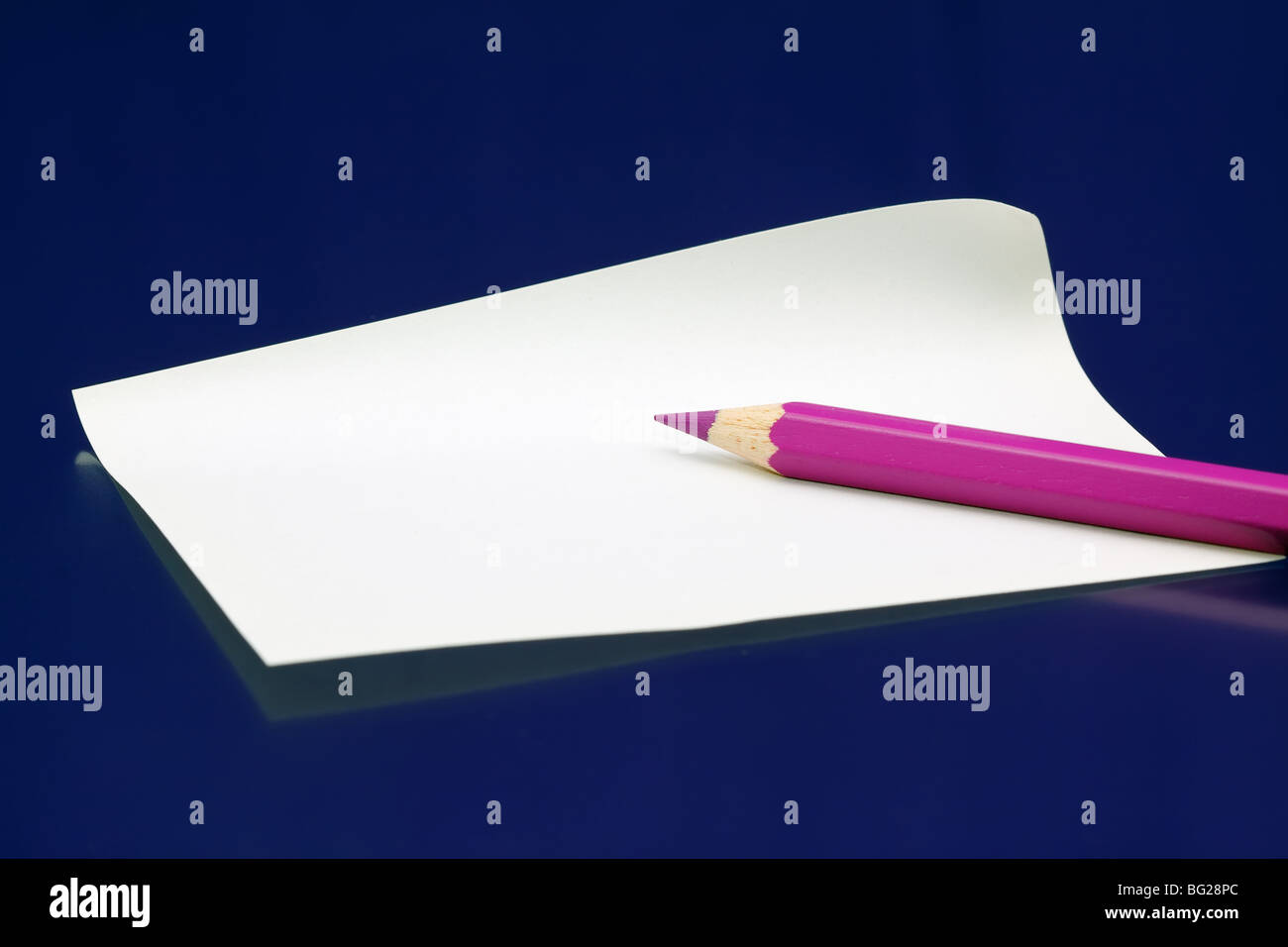 pink pencil on empty white paper note against dark blue Stock Photo - Alamy