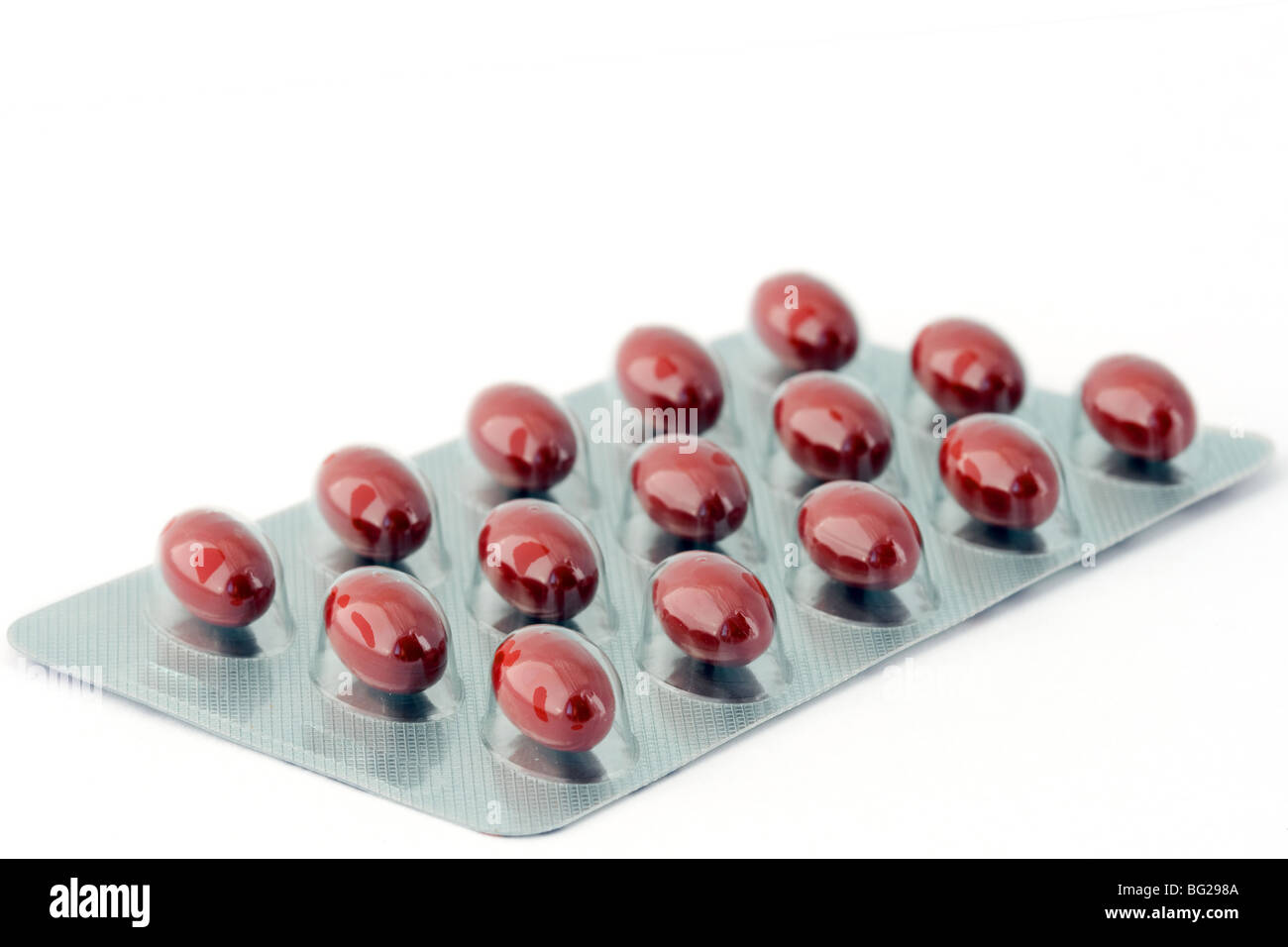 Red pills in strip - clipping path included Stock Photo - Alamy