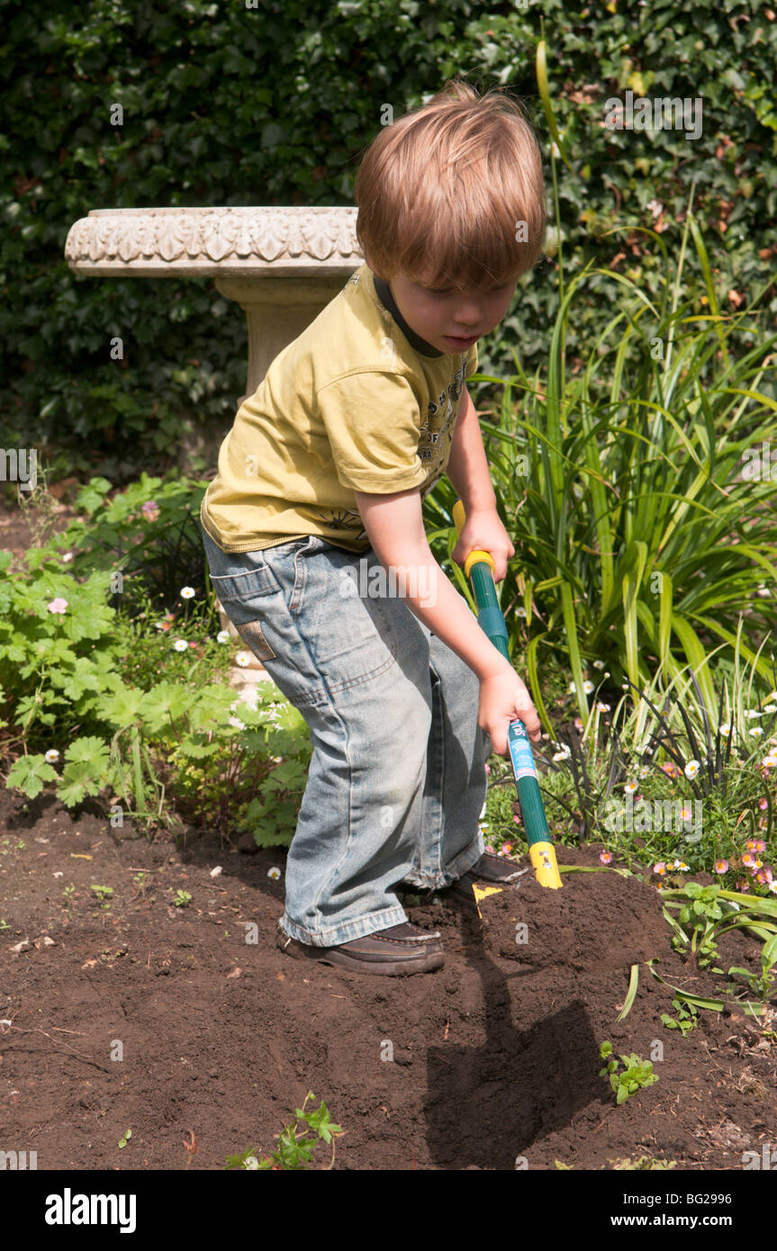 Boy digging soil hi-res stock photography and images - Alamy