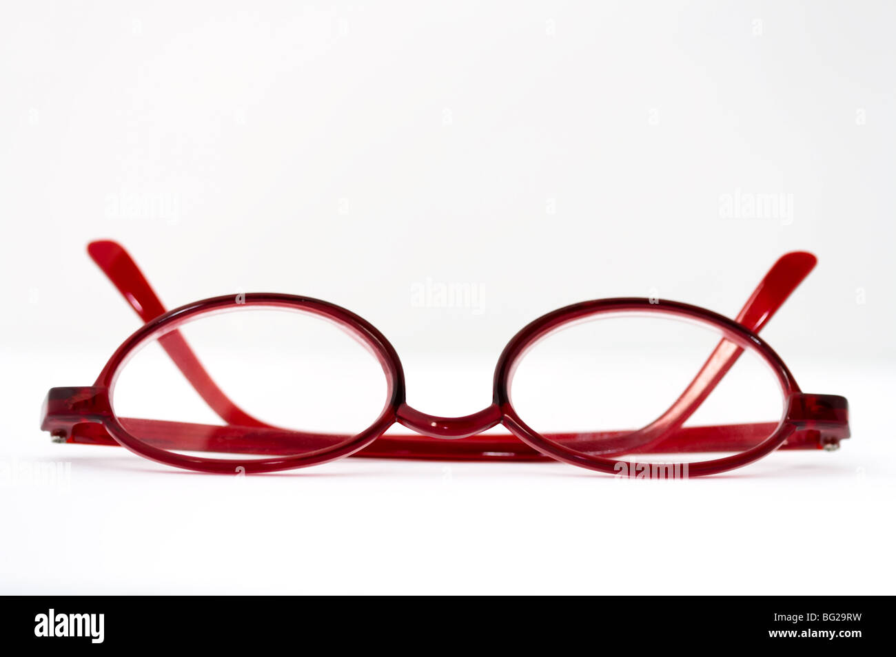 Closed red reading glasses isolated on white Stock Photo - Alamy