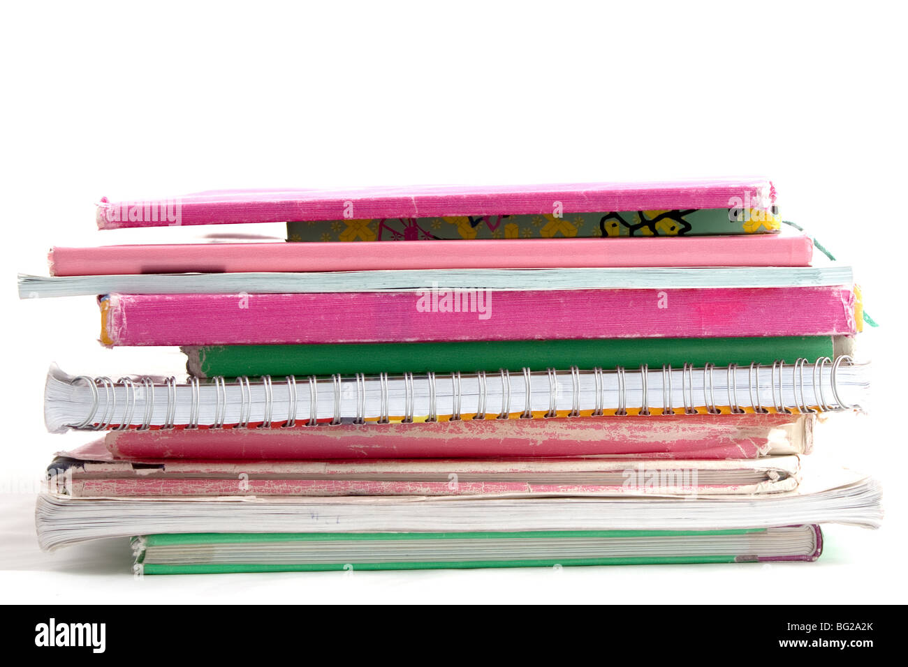 pile of schoolbooks in pink and light green paper isolated on white ...