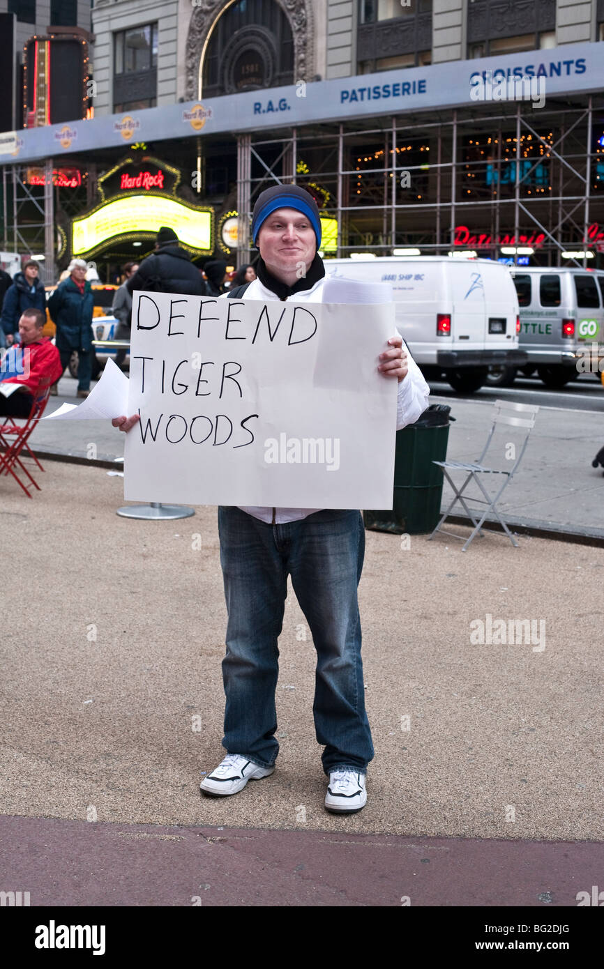 young man standing in Times Square pedestrian mall in New York City ...