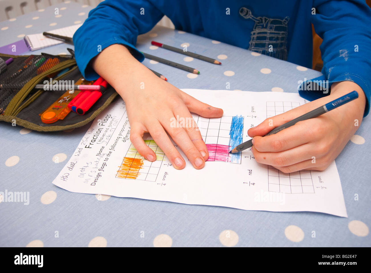 A MODEL RELEASED picture of a ten year old boy doing his maths homework ...