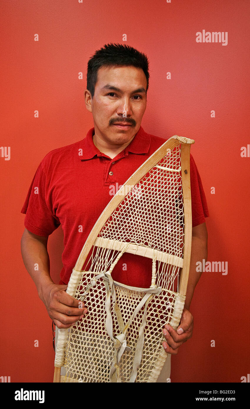 Cree man shows typical hand made snowshoe used by his people in winter ...