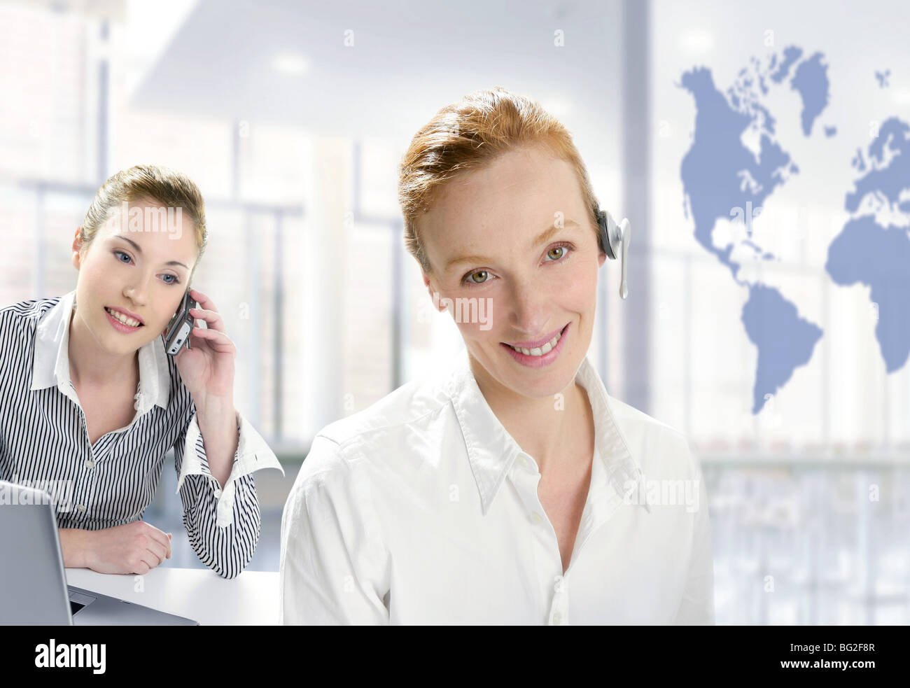 Modern office, two beautiful businesswoman, helpdesk, customer service ...