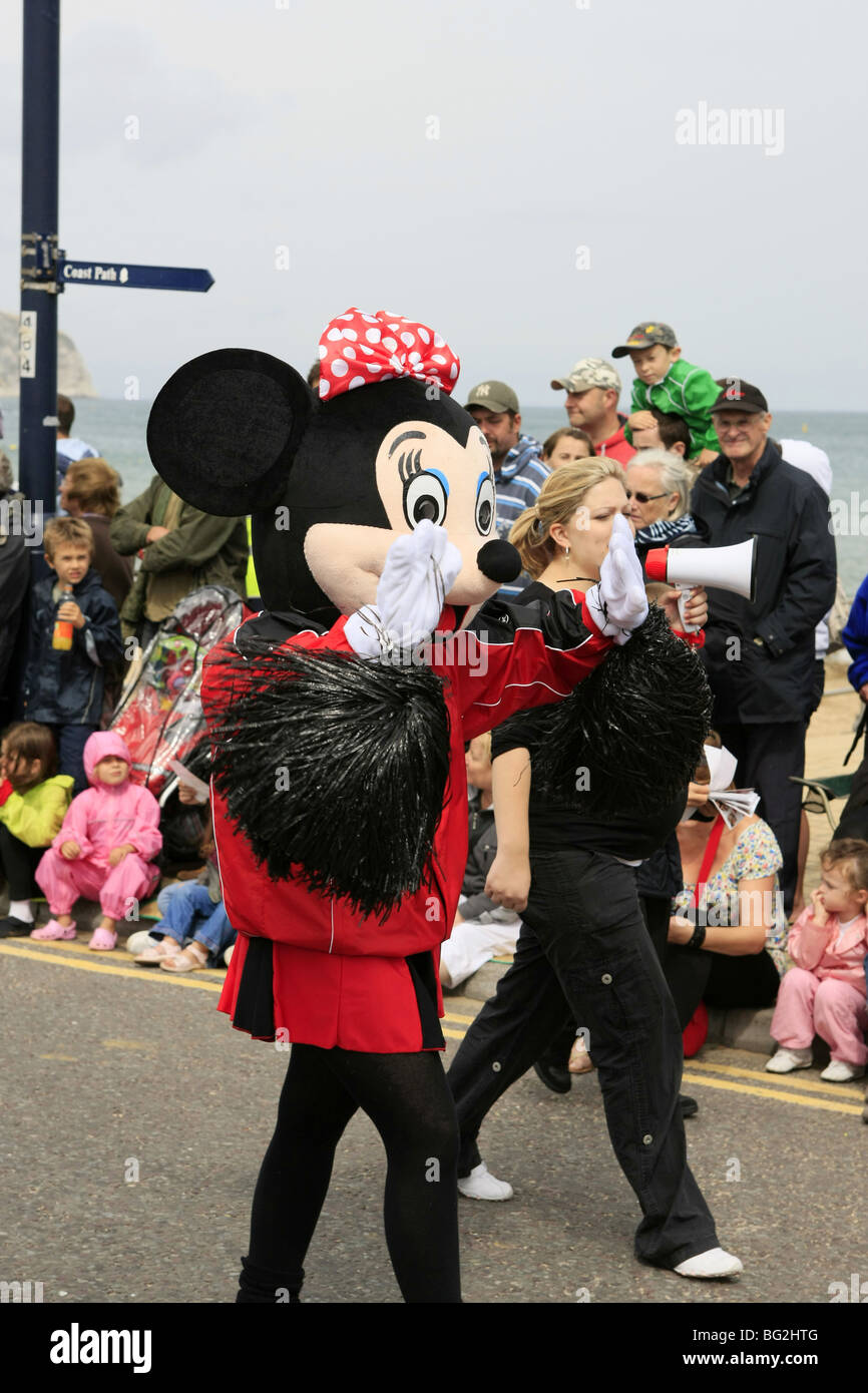 Minnie Mouse waves to people as she takes part in a carnival parade in ...
