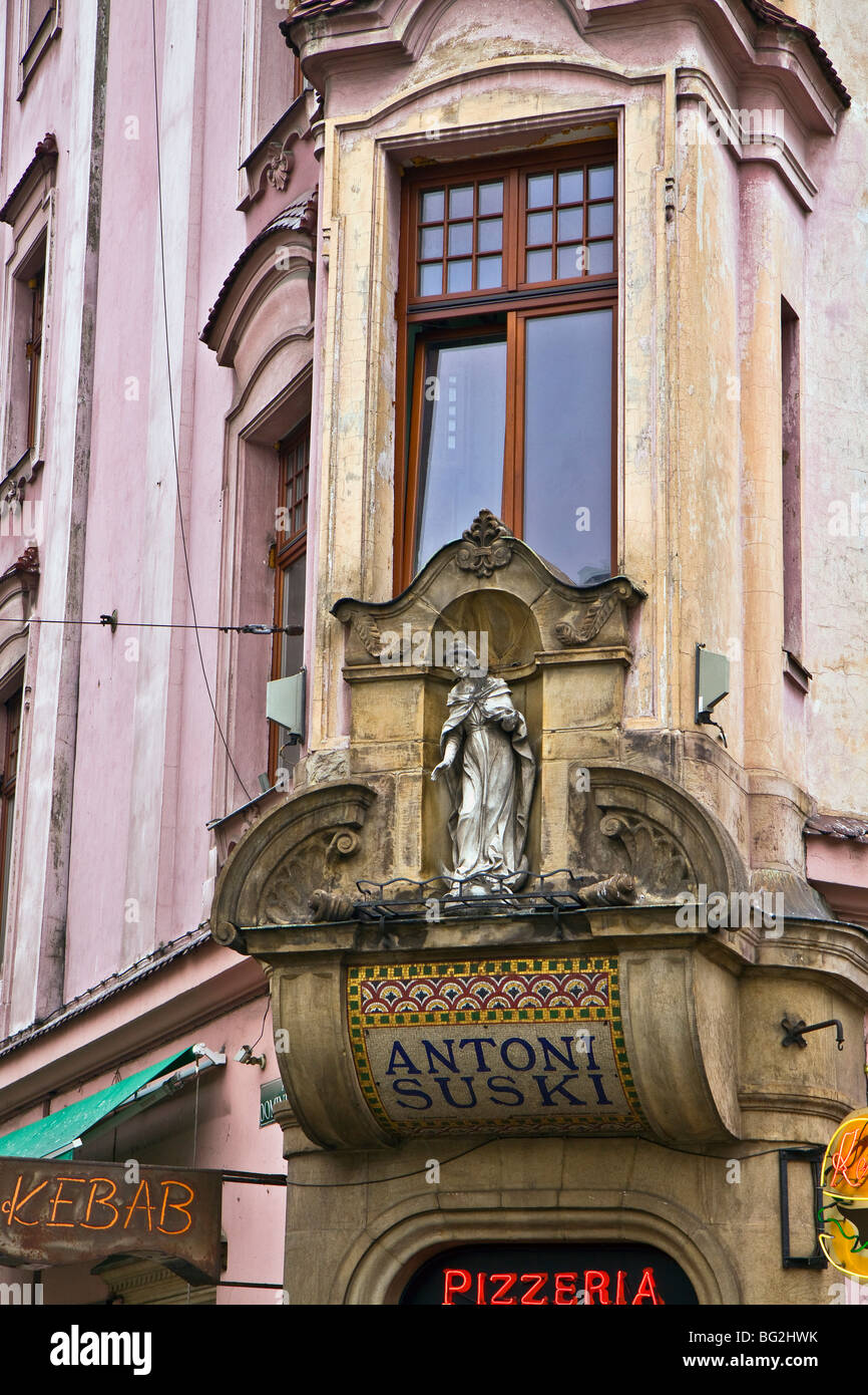 Religious statue under a corner window Stock Photo - Alamy