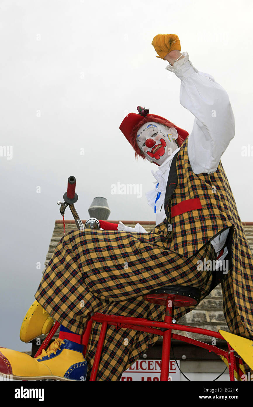 Clown waving to the crowds at the Swanage Carnival Dorset England Stock ...