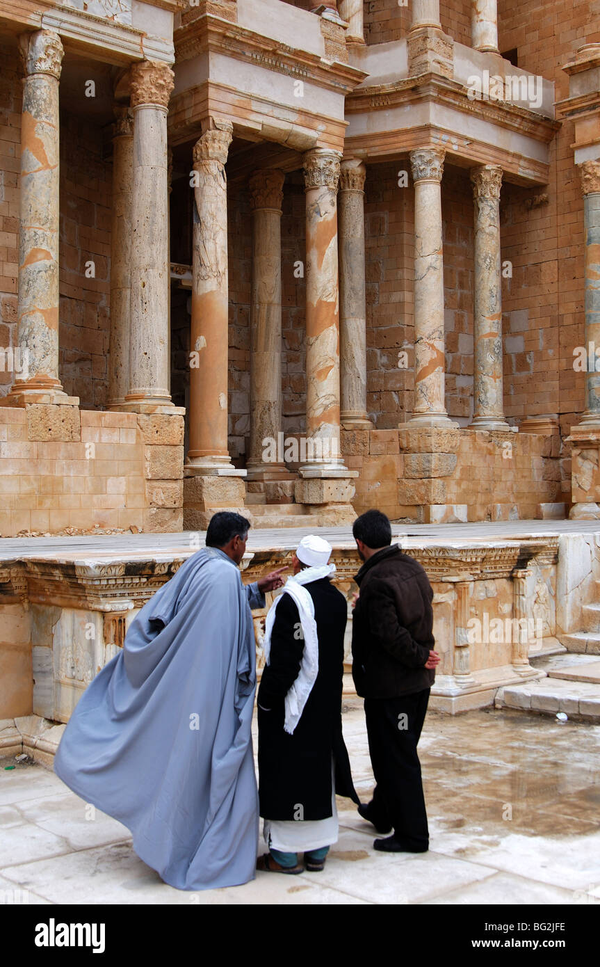 Three Arab men in traditional costumes discussing in the theatre of ...