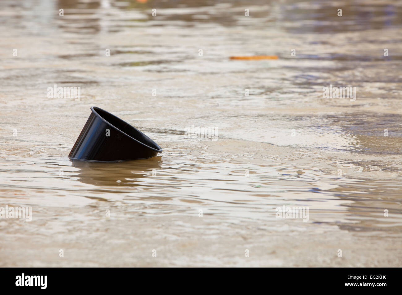 A bucket floats down Cockermouths main street during the devastating ...