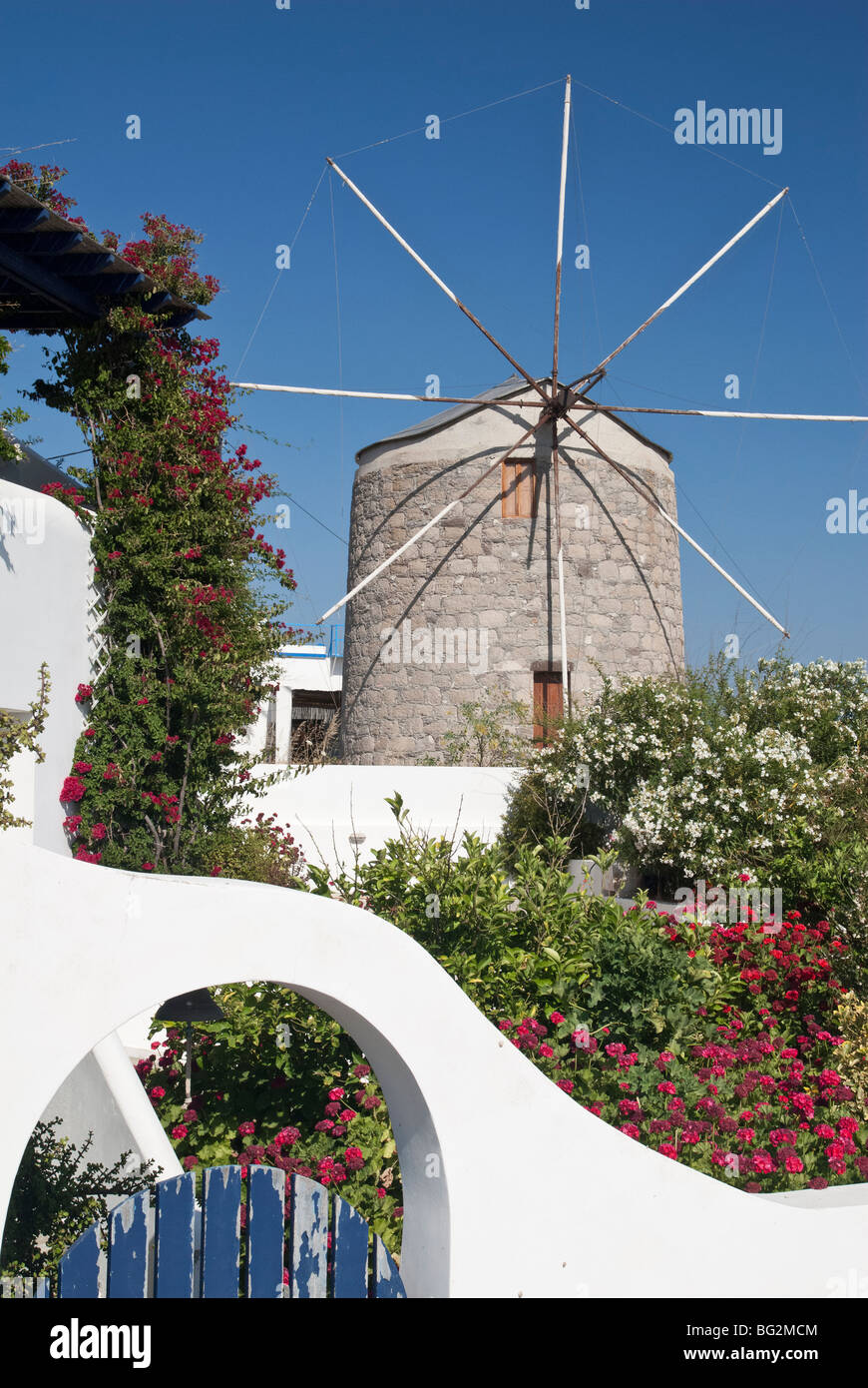 Greek garden and restored stone windmill on Milos Island, Greece Stock ...