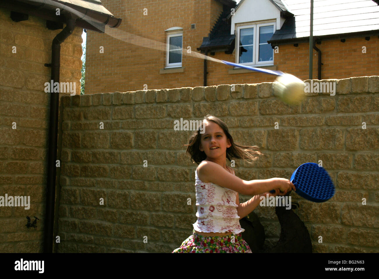 Girl, 10 playing swingball in garden Stock Photo - Alamy