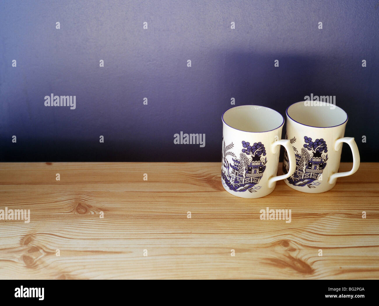 Two empty tea mugs on a table in the afternoon Stock Photo - Alamy
