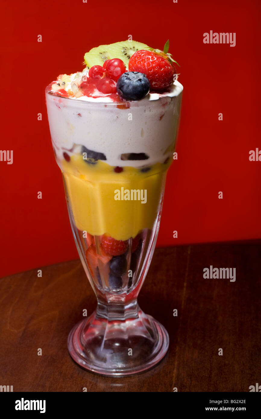 Mango Sundae with vanilla ice cream and strawberry, blueberry ...