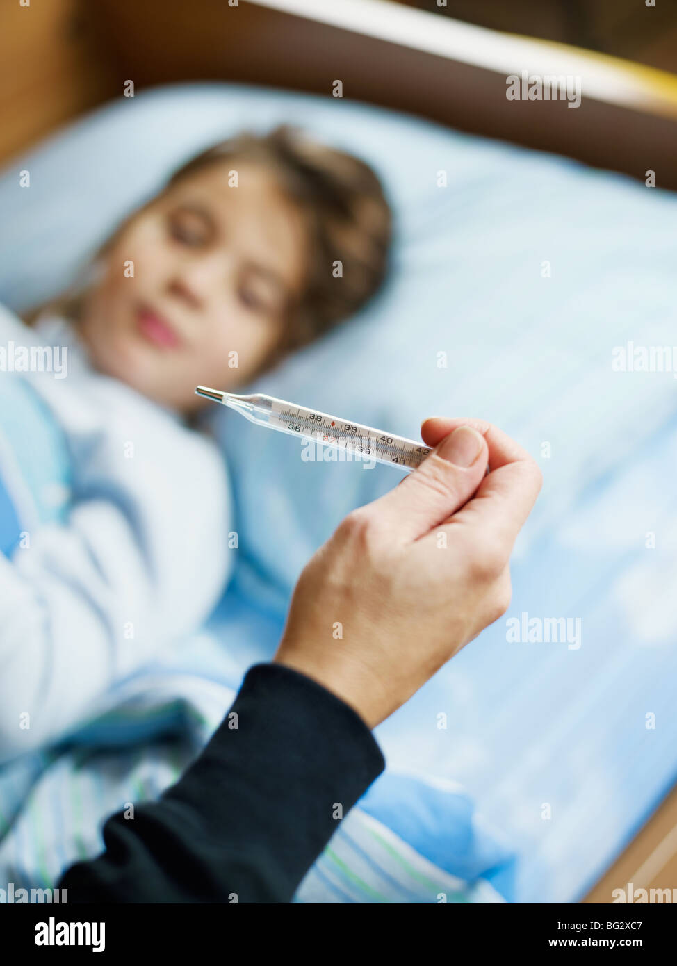 mom taking temperature to her daughter Stock Photo - Alamy