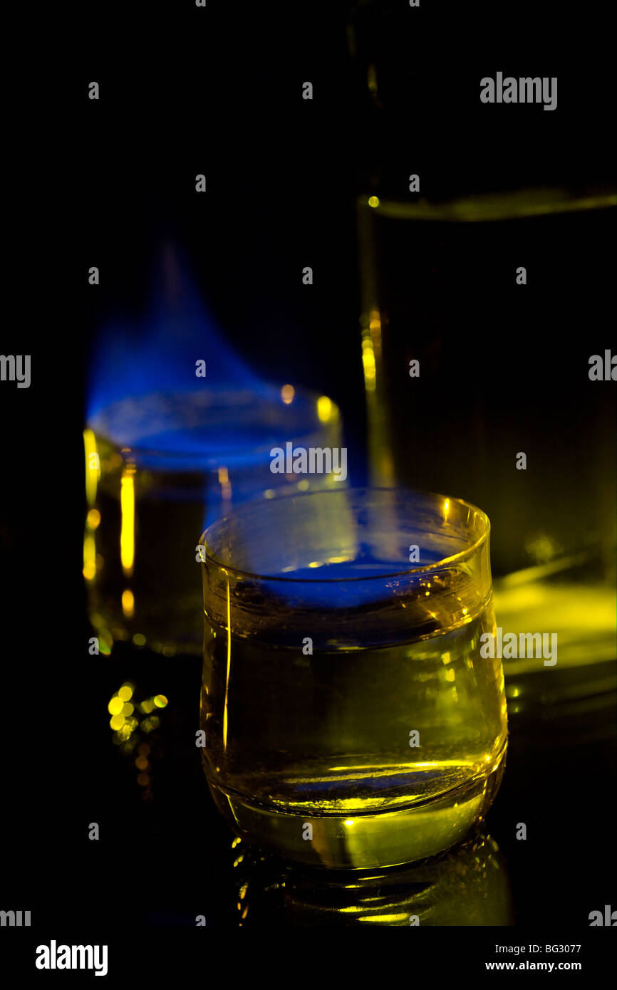 Dark blue flame of burning alcoholic drinks on a black background Stock ...