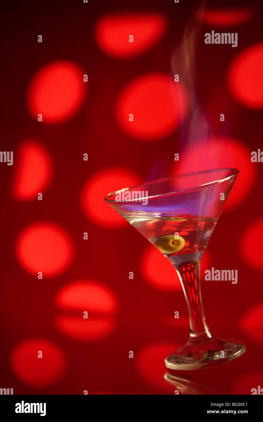 Blue flame of burning alcoholic drinks on a red background Stock Photo ...