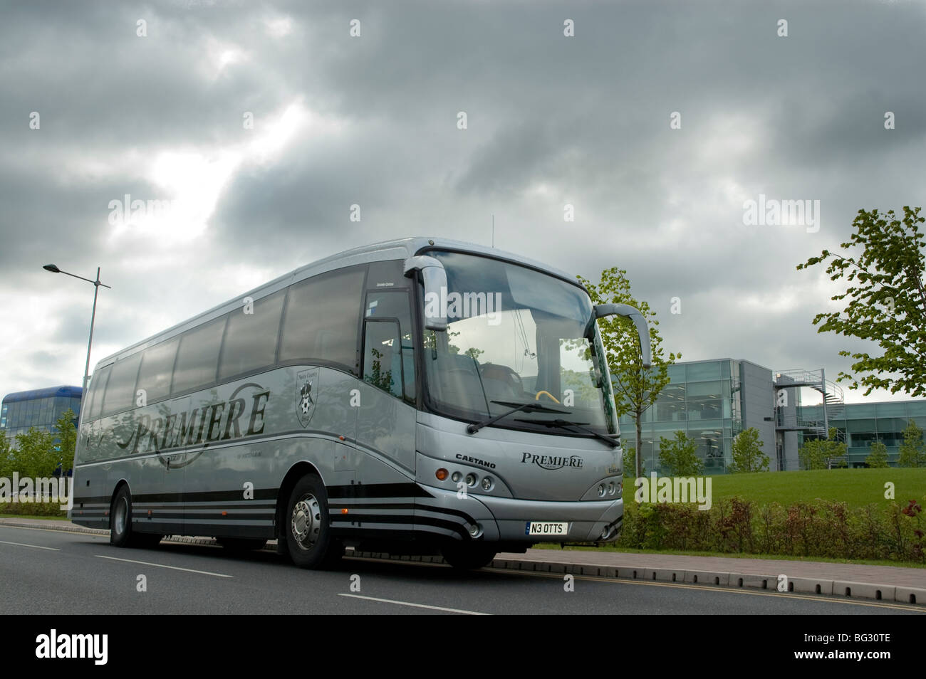 Grey coach in modern office building environment Stock Photo - Alamy