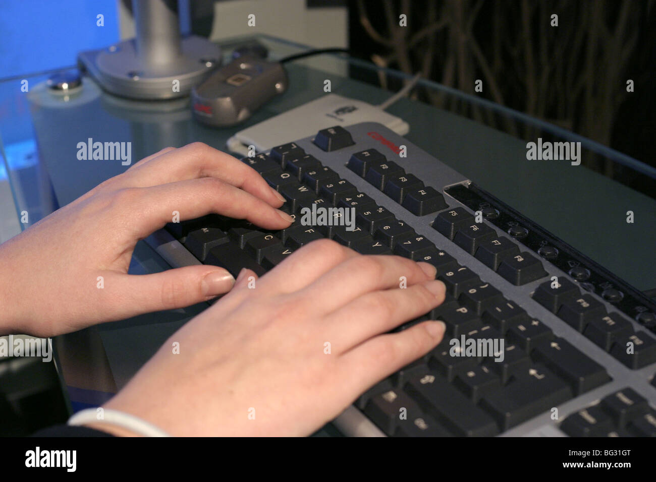 Girl typing on a computer keyboard Stock Photo - Alamy
