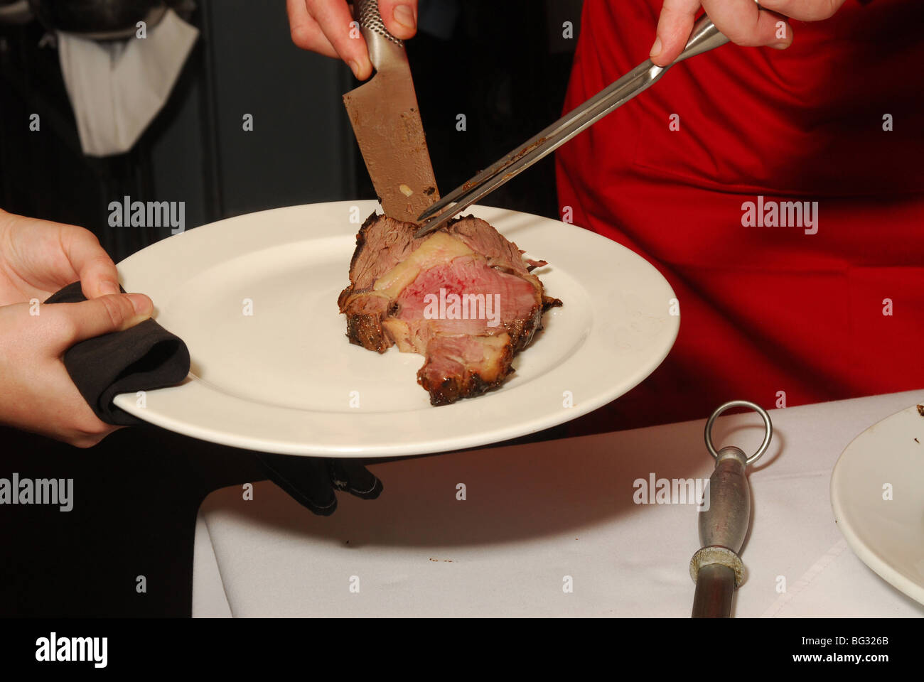 A chef serving a slice of beef Stock Photo - Alamy