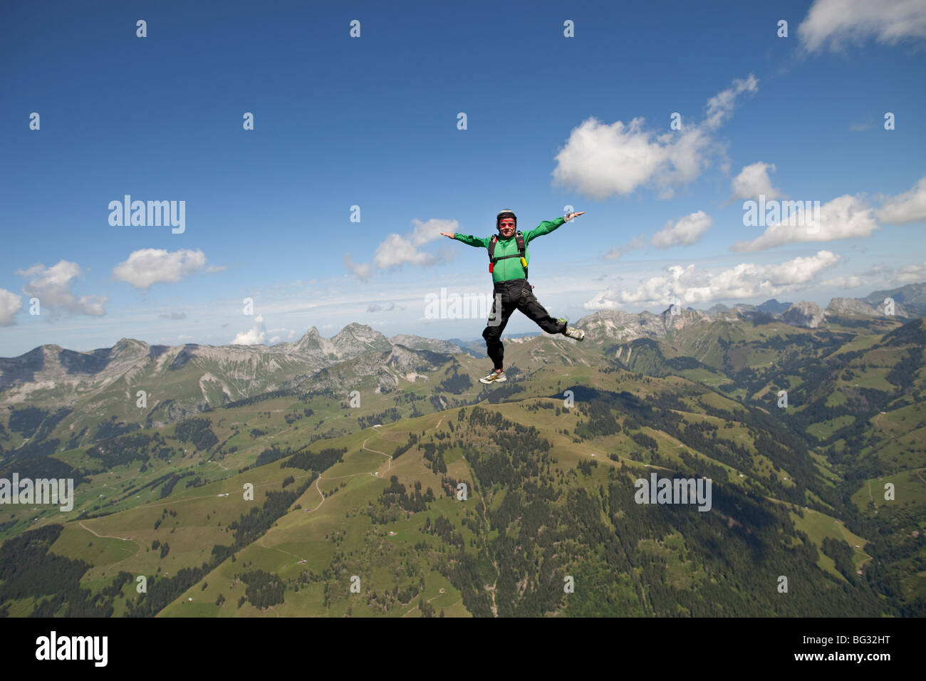 Skydiver is flying head up within the sit fly position over a ...