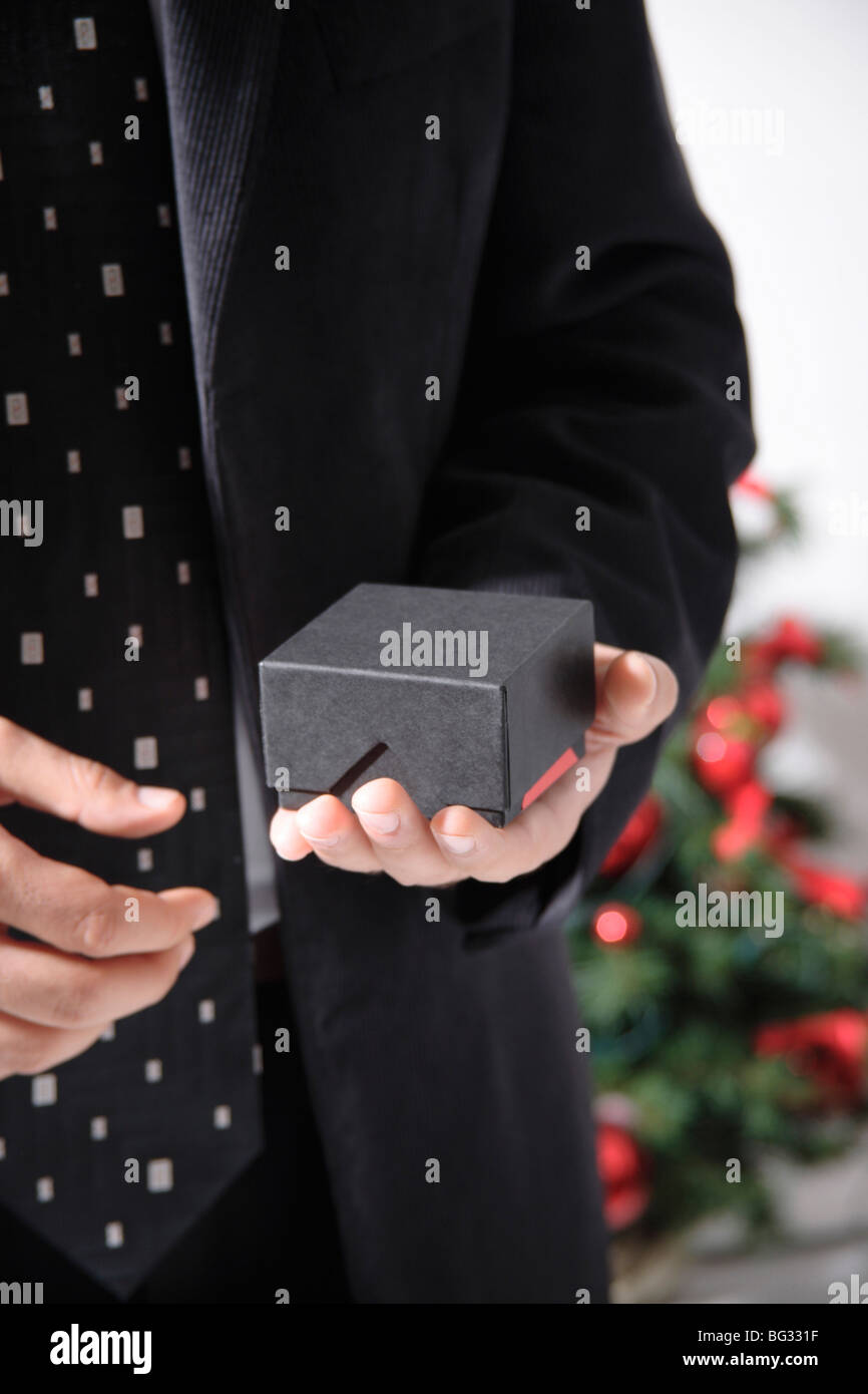 Man with christmas present Stock Photo - Alamy