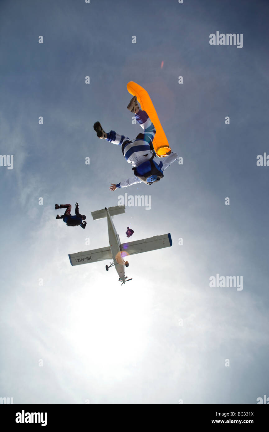 Skydivers with colorful tubes exit out of the plane. The Freeflyers are ...