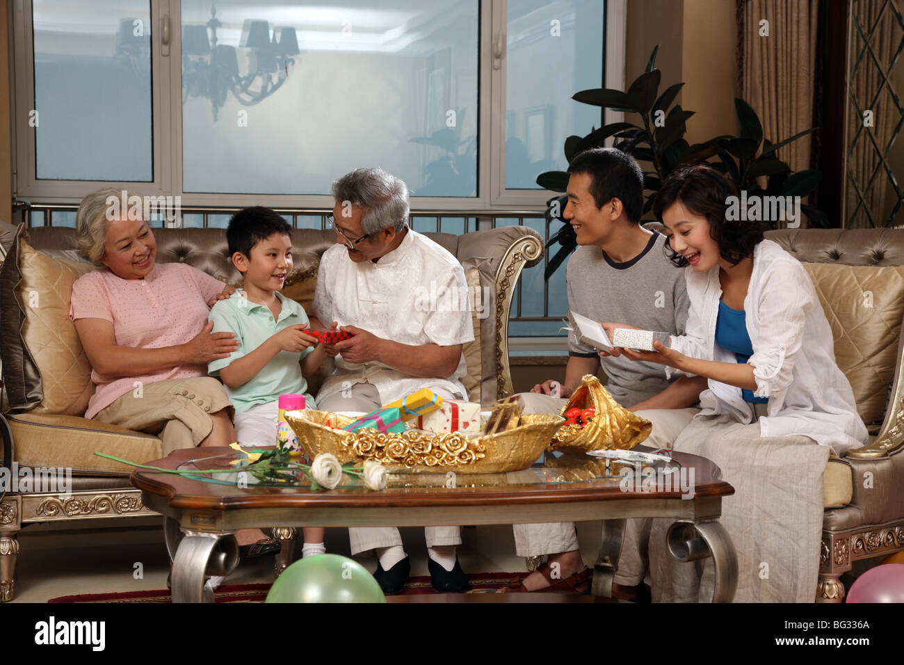 multi-generation family chatting at home Stock Photo - Alamy