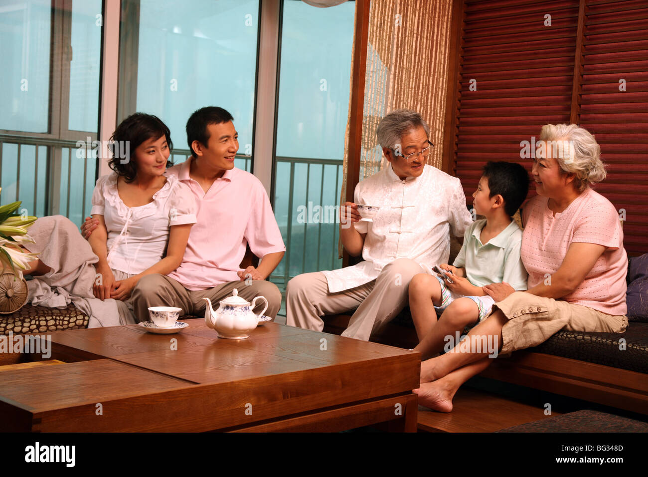 multi-generation family chatting at home Stock Photo - Alamy