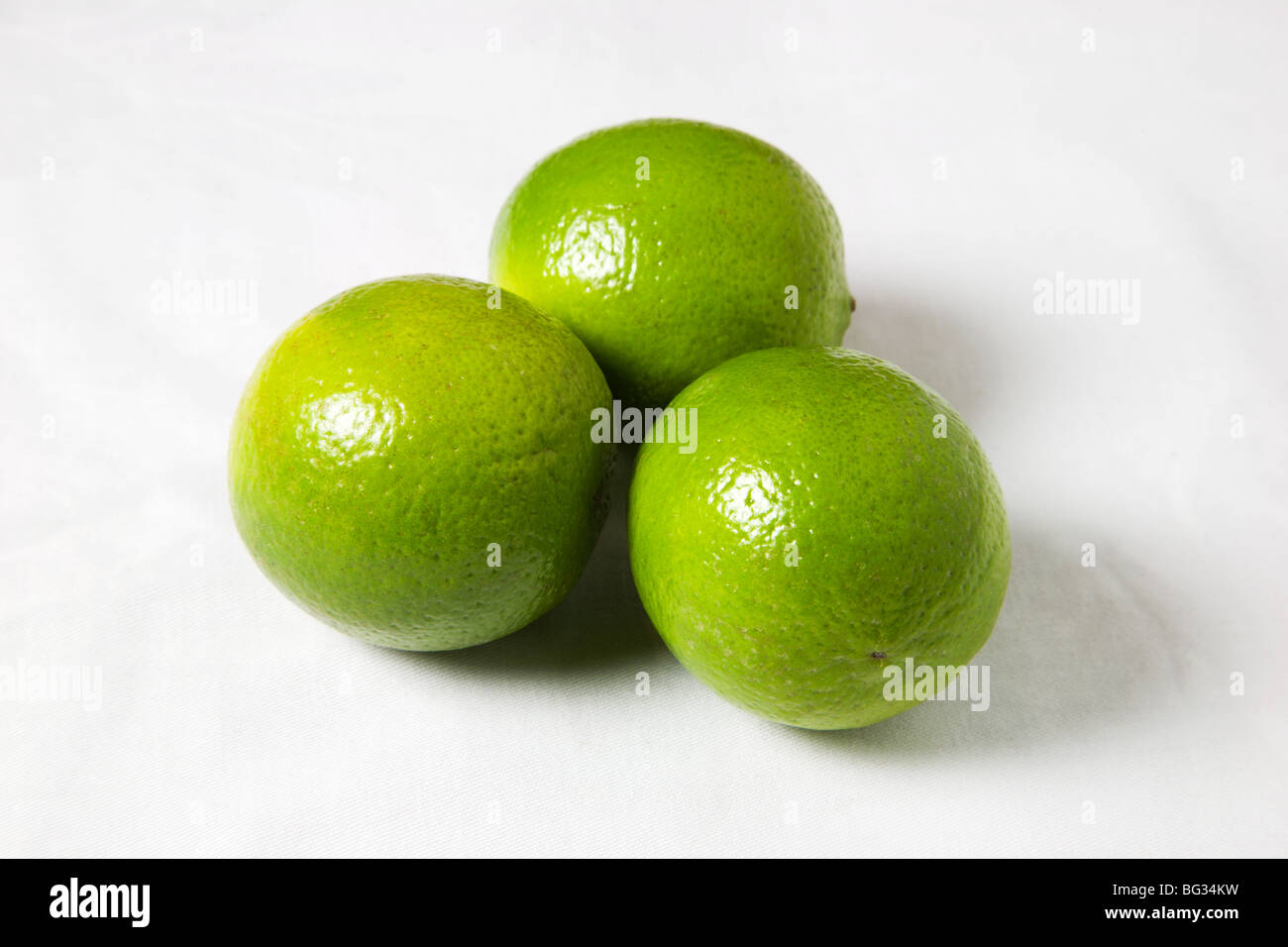 Three Limes on a White Background Stock Photo - Alamy