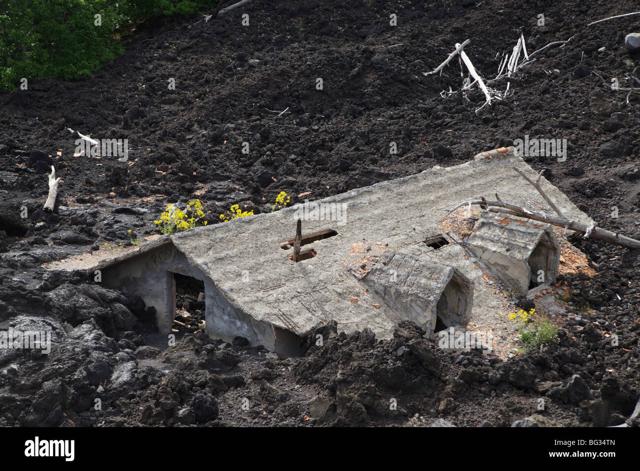 Italy, Sicily, Etna volcano island House partially covered by lava ...