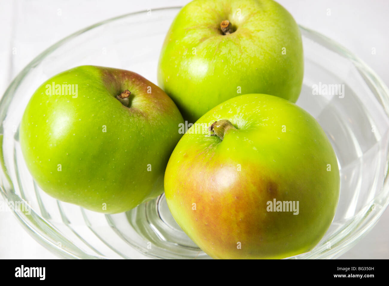 Three Bramley Cooking Apples in a Glass Bowl Stock Photo - Alamy