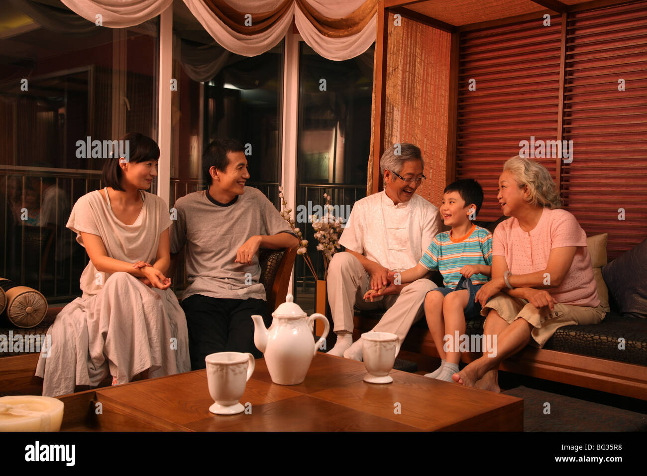 multi-generation family chatting at home Stock Photo - Alamy