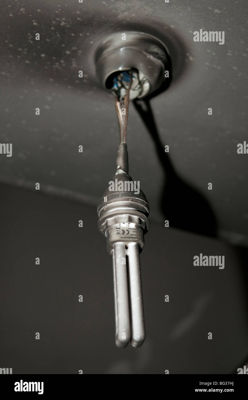 melted and fire damaged low energy light bulb in ceiling pendant Stock ...