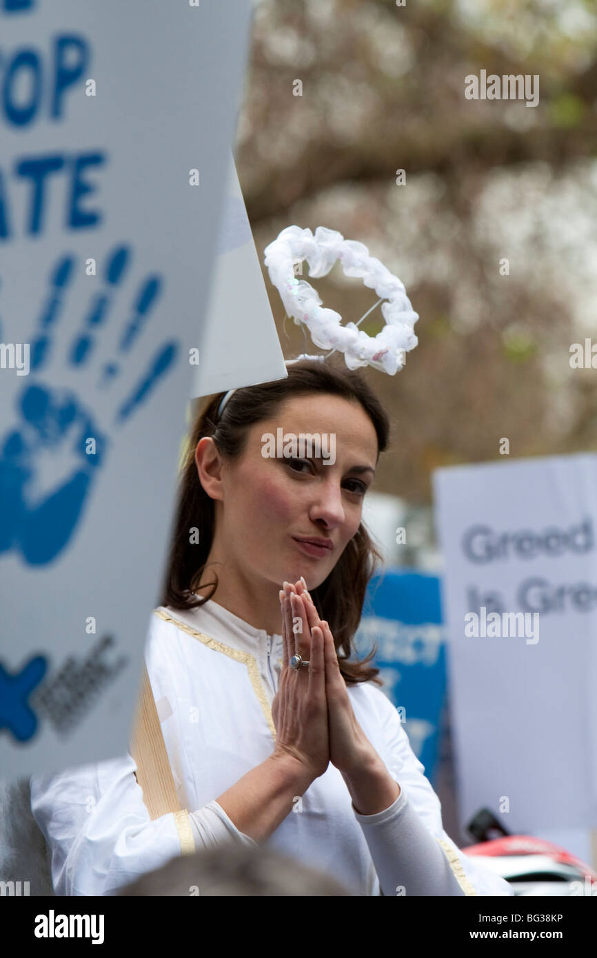 Female demonstrator, dressed as an angel and praying for change, on the ...
