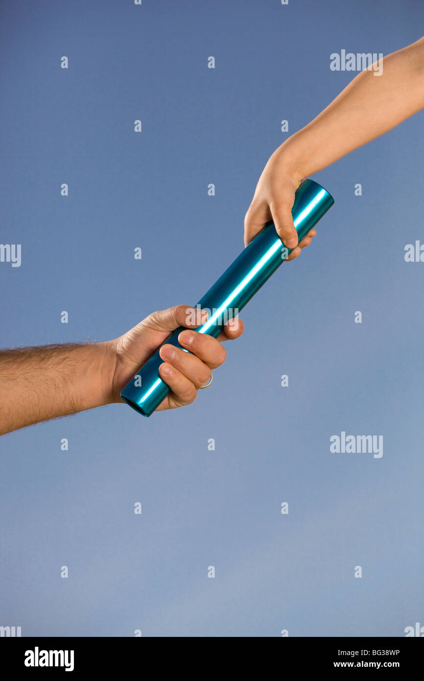 Father handing off a baton to his son Stock Photo - Alamy