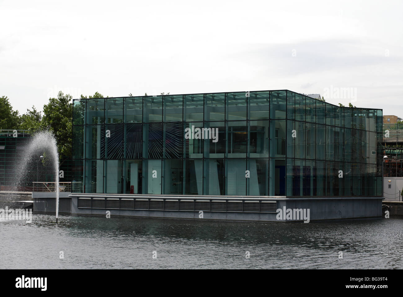 office building on water in the docklands Stock Photo - Alamy