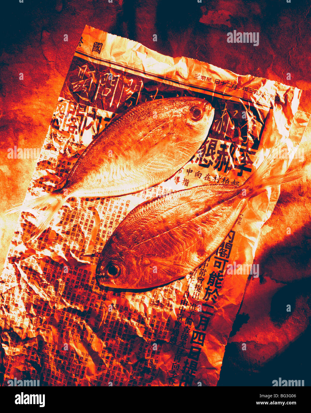 Two small whole fish on a Chinese newspaper Stock Photo - Alamy