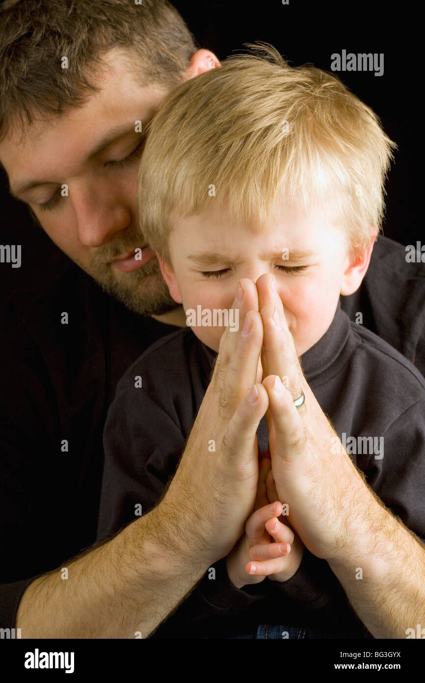 Father praying with son Stock Photo - Alamy