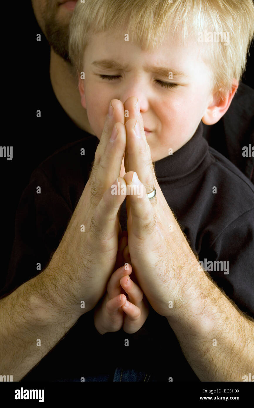 Father praying with son Stock Photo - Alamy