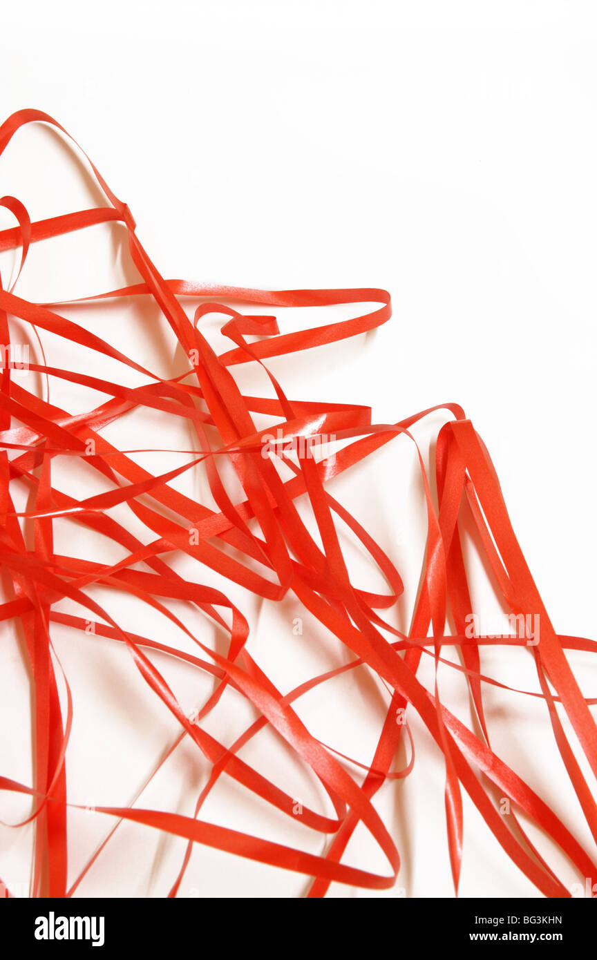 Narrow red ribbon lying on white Stock Photo - Alamy